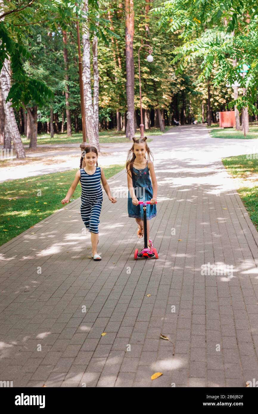 Children riding their scooters hi-res stock photography and images - Alamy