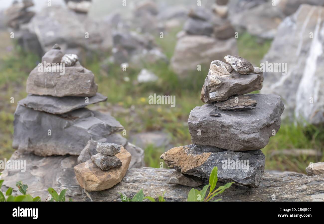 Two piles of rocks on a mountain side in damp weather Stock Photo - Alamy