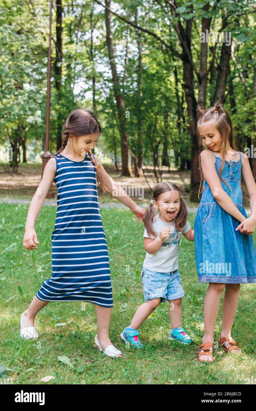 Happy active kids playing on green grass in spring park Stock Photo - Alamy