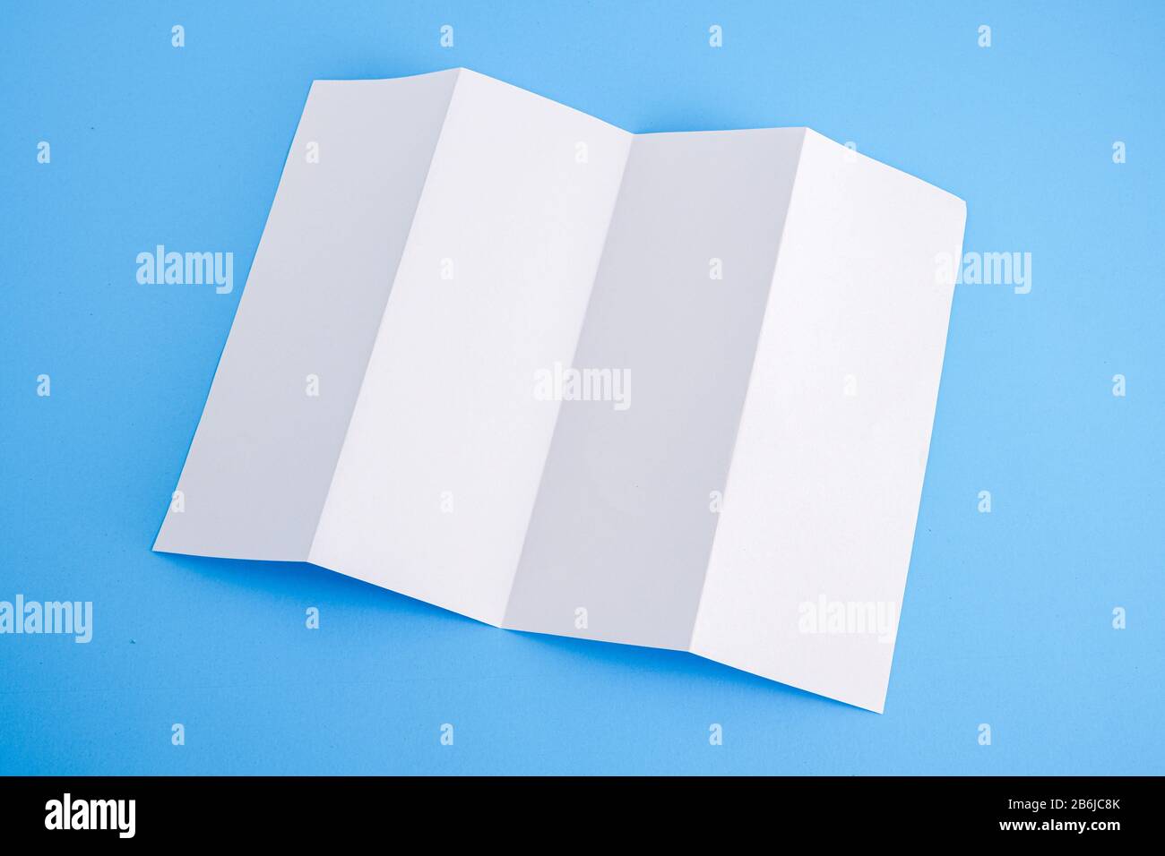 template fold white paper on blue background Stock Photo - Alamy