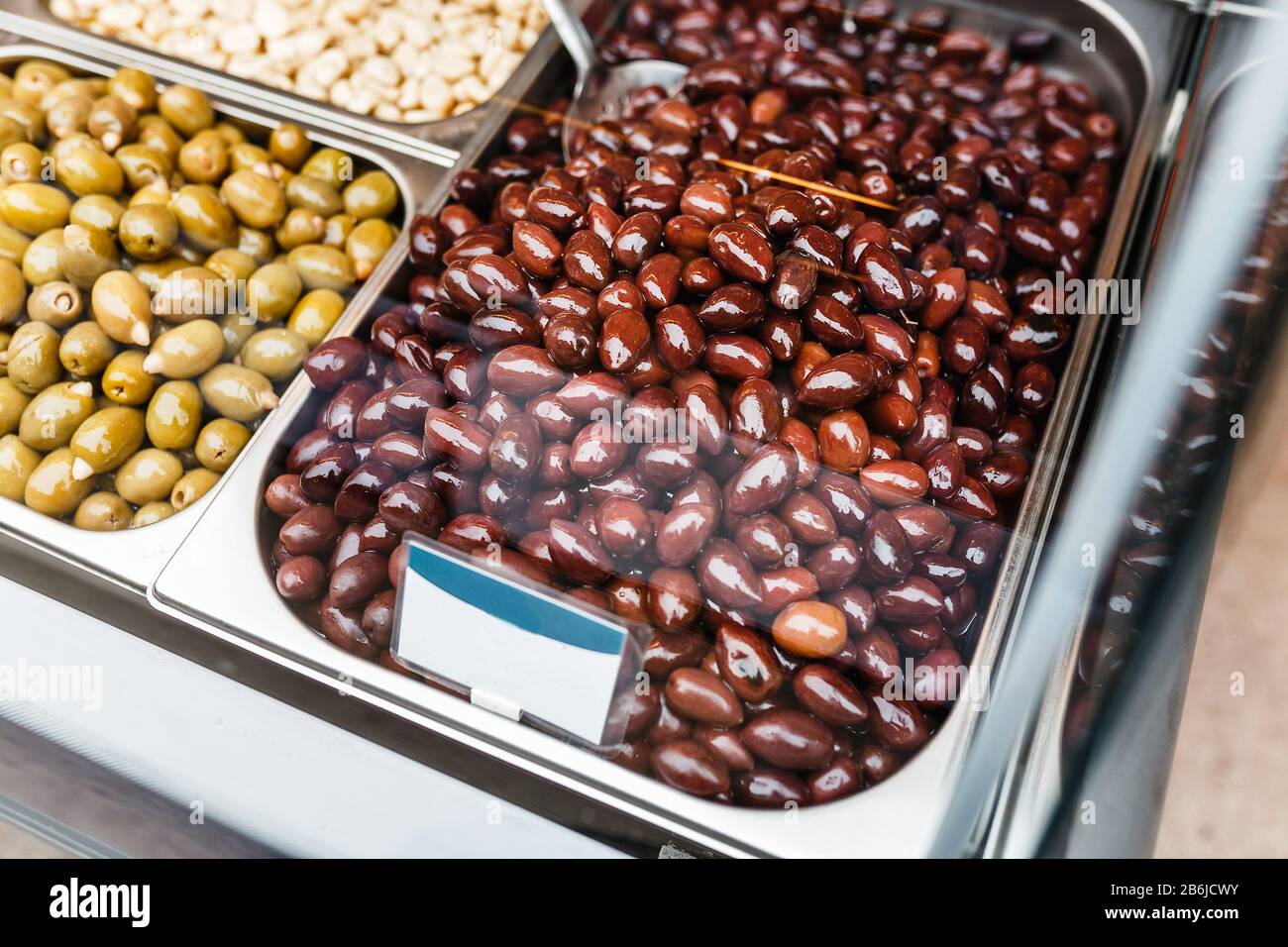 Bowls of various olives for sale at a open street market with price ...