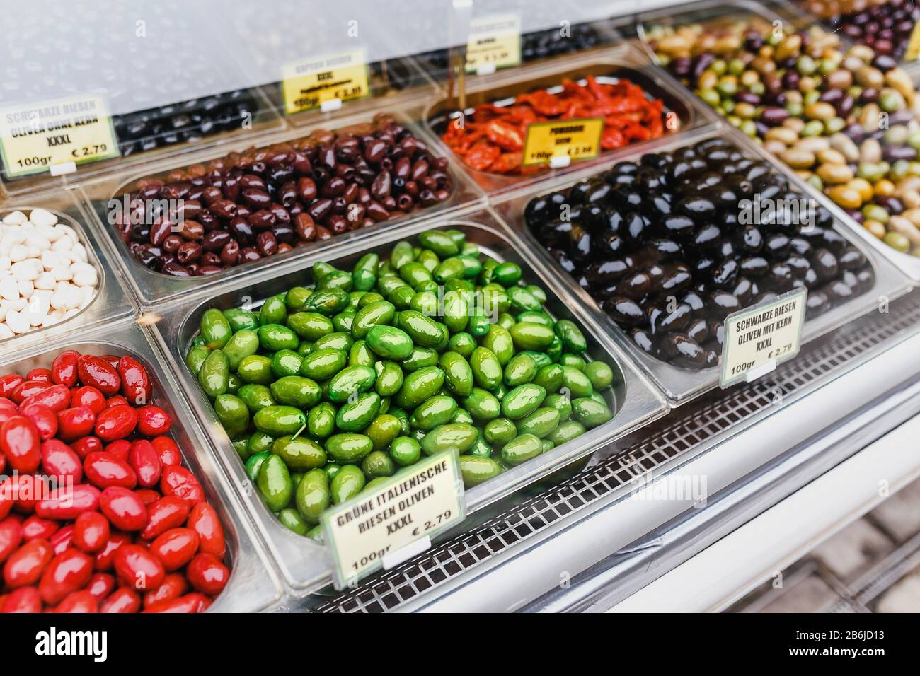 Bowls of various olives for sale at a open street market with price ...