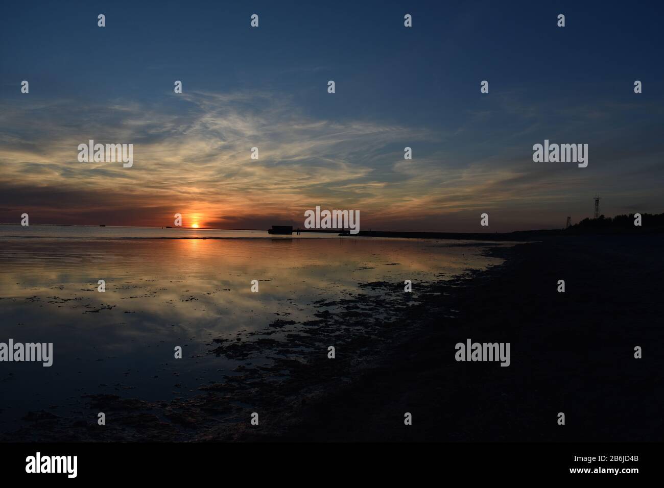 Beautiful orange sunset sky reflection on calm sea Stock Photo - Alamy