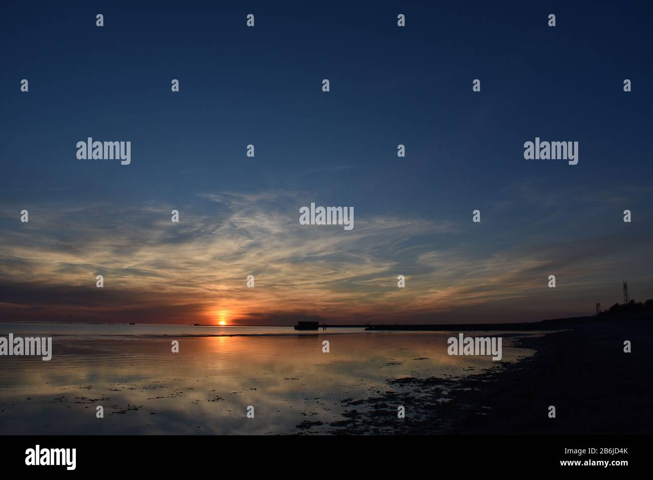 Beautiful orange sunset sky reflection on calm sea Stock Photo - Alamy