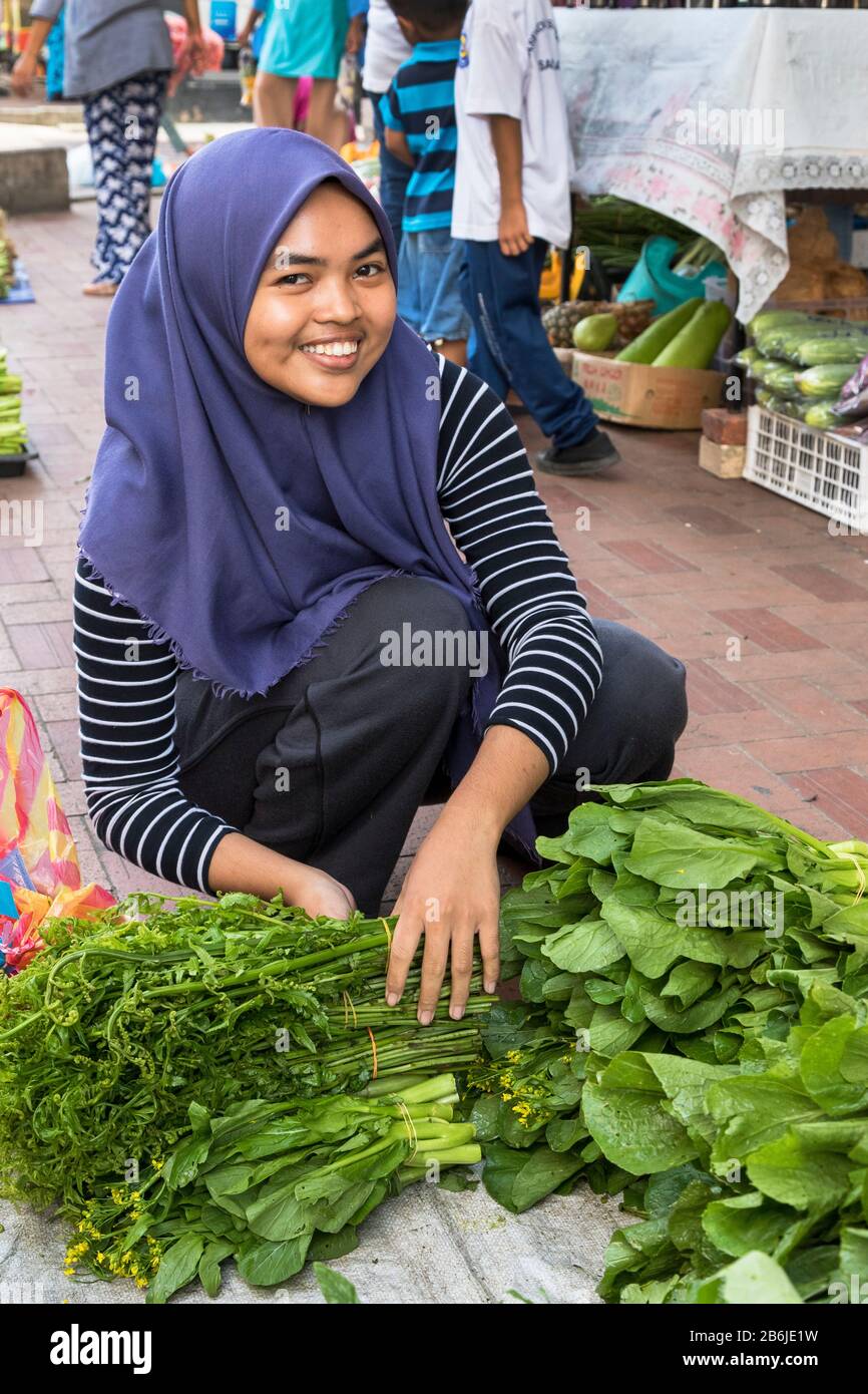 local woman selling fresh vegetables on the pavement, Sandakan, Sabah ...