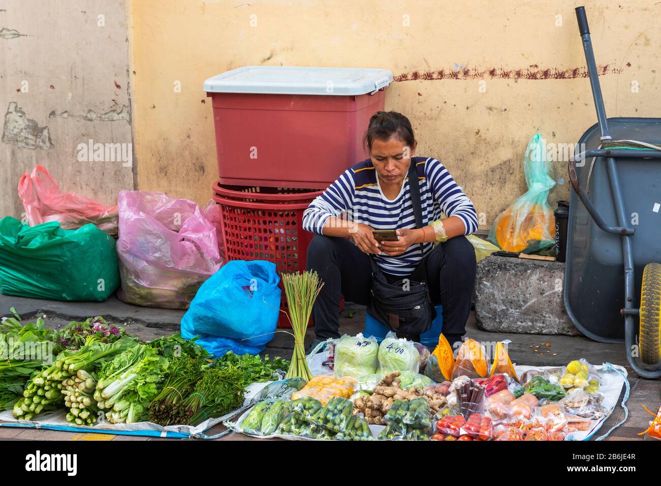 local woman selling fresh vegetables on the pavement, Sandakan, Sabah ...