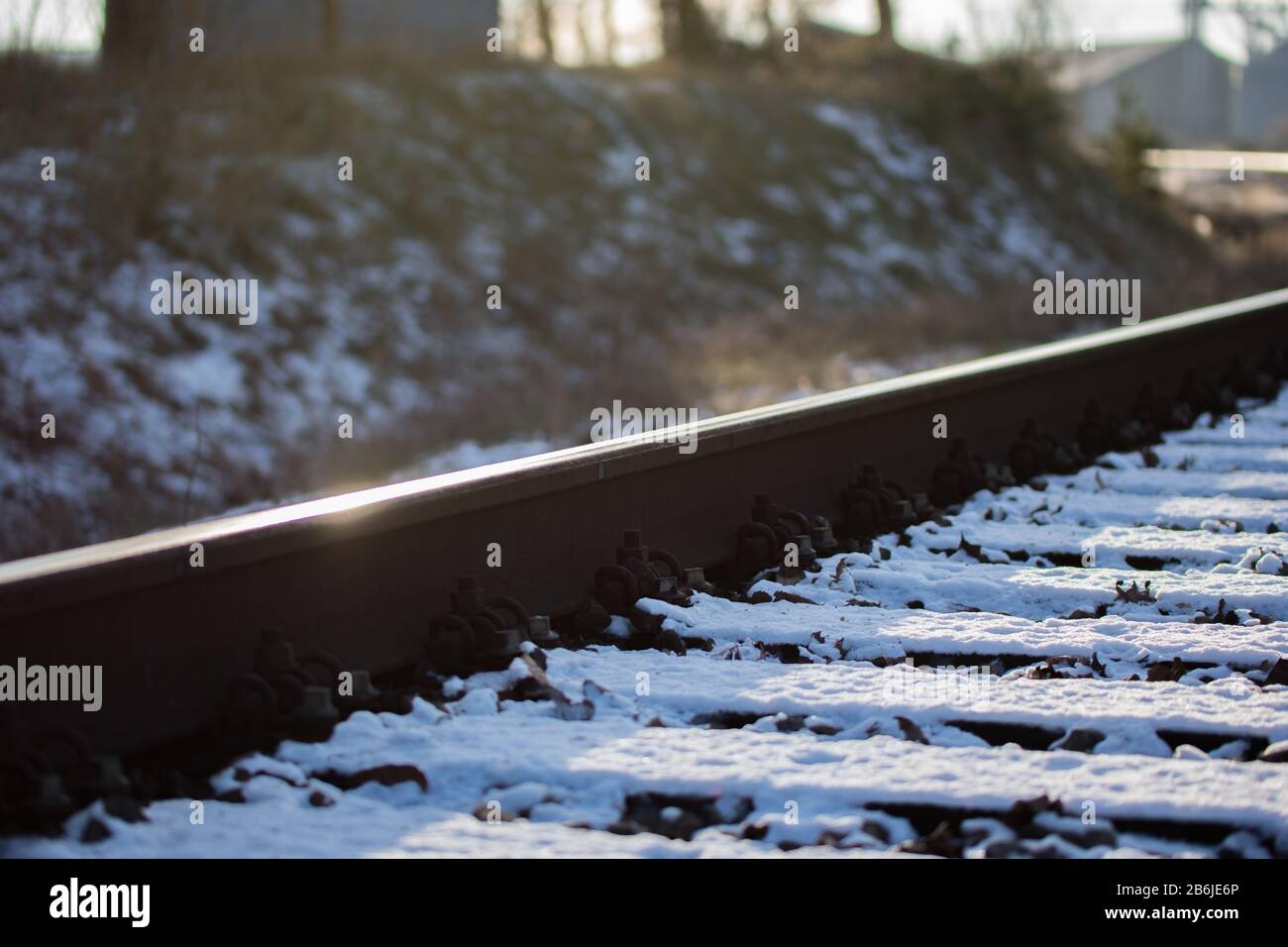 Sun reflecting on railroad rail in winter with snow background Stock ...
