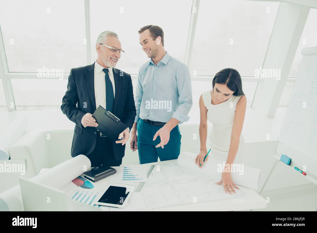 Team of hardworking architects working on new plan of building Stock ...