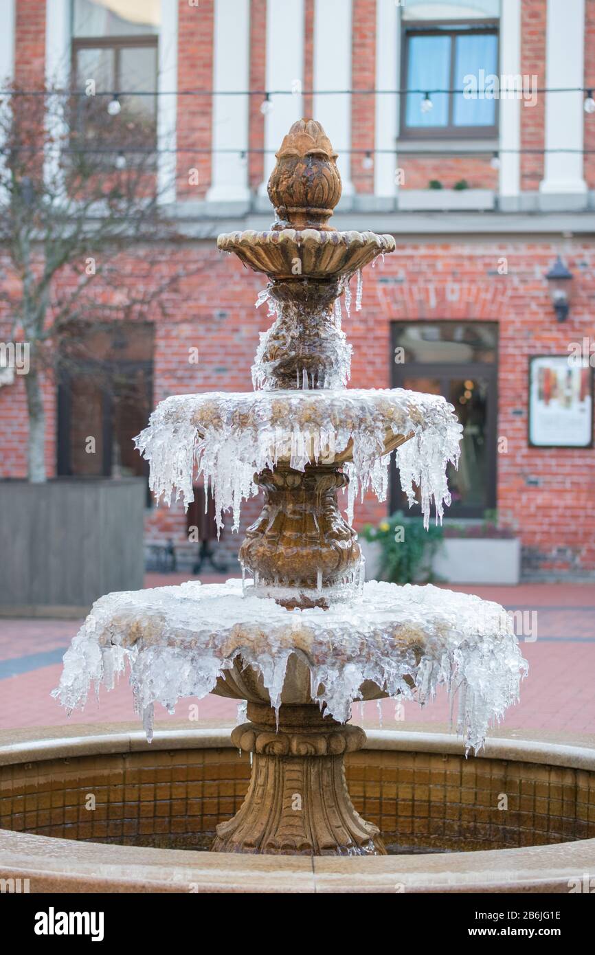 Beautiful frozen water fountain with icicle formations all around Stock ...