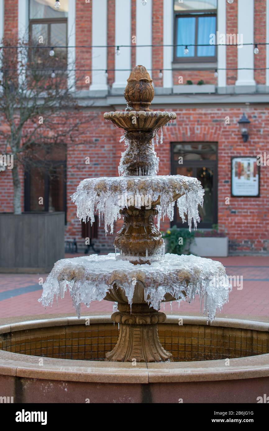 Beautiful frozen water fountain with icicle formations all around Stock ...