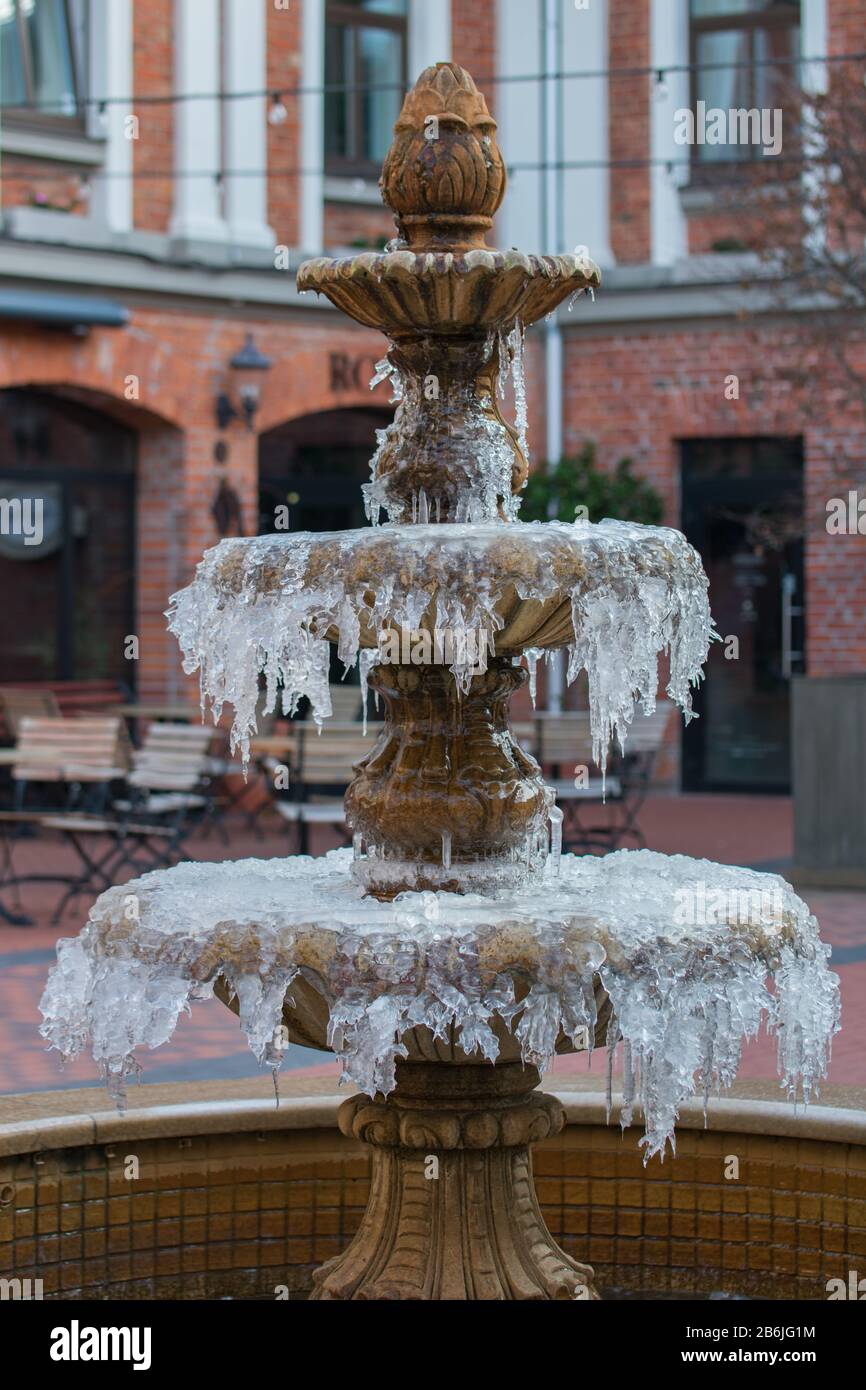 Beautiful frozen water fountain with icicle formations all around Stock ...