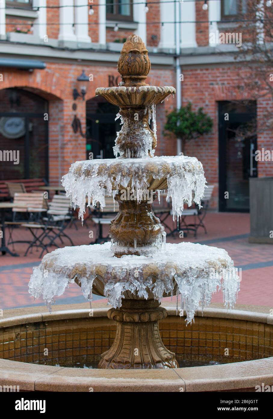 Beautiful frozen water fountain with icicle formations all around Stock ...