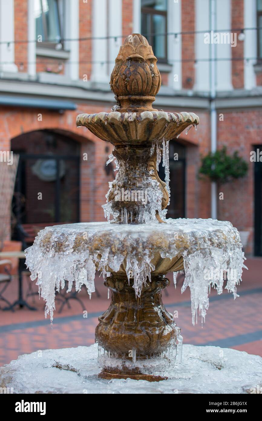 Beautiful frozen water fountain with icicle formations all around Stock ...