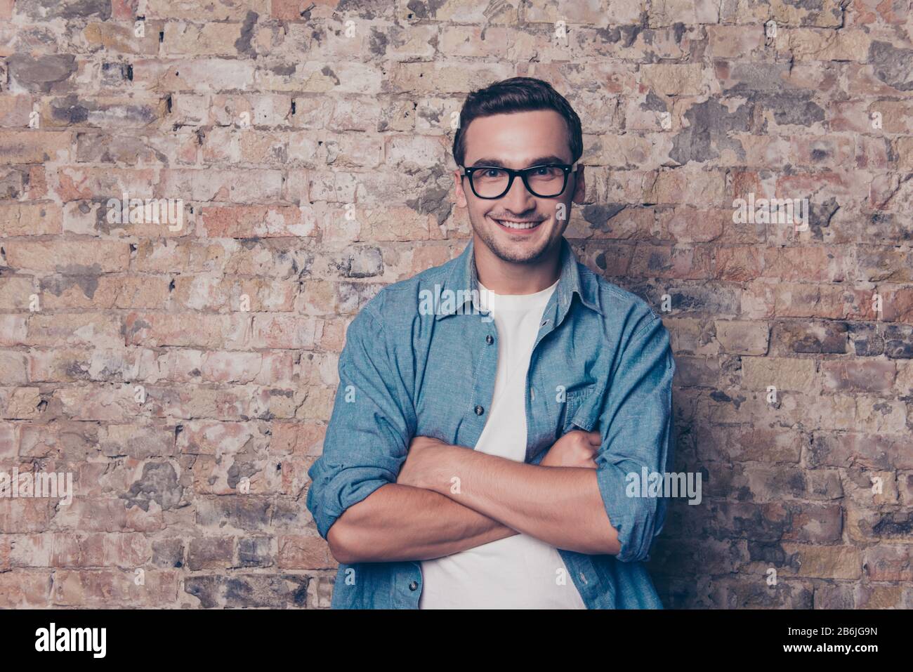 Portrait of happy smiling smart man with crossed hands Stock Photo - Alamy