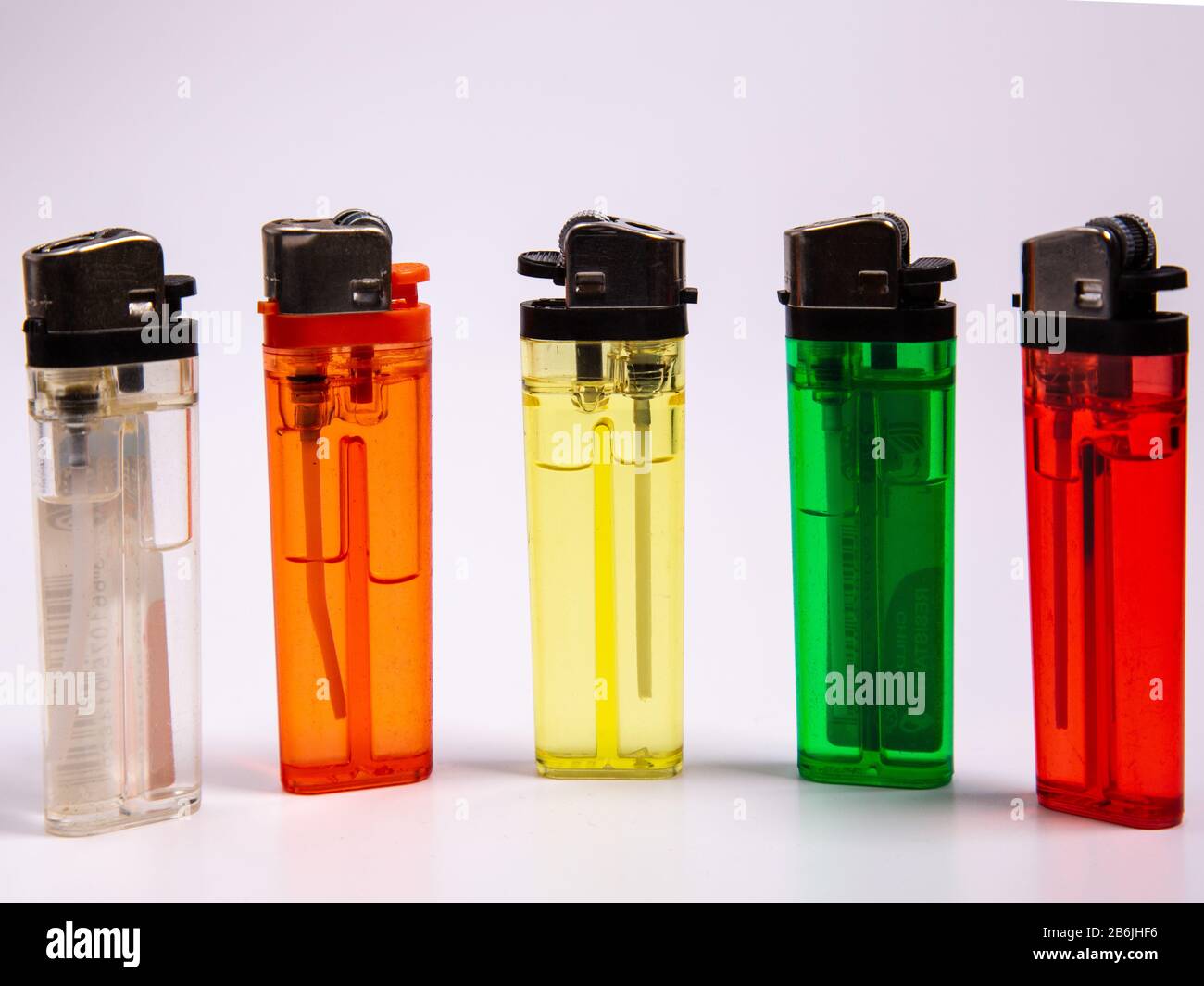five gas lighters in different colours on a white background Stock ...