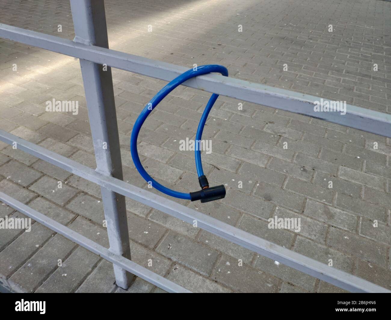 Bike lock attached to metal railing with bicycle missing, presumably ...