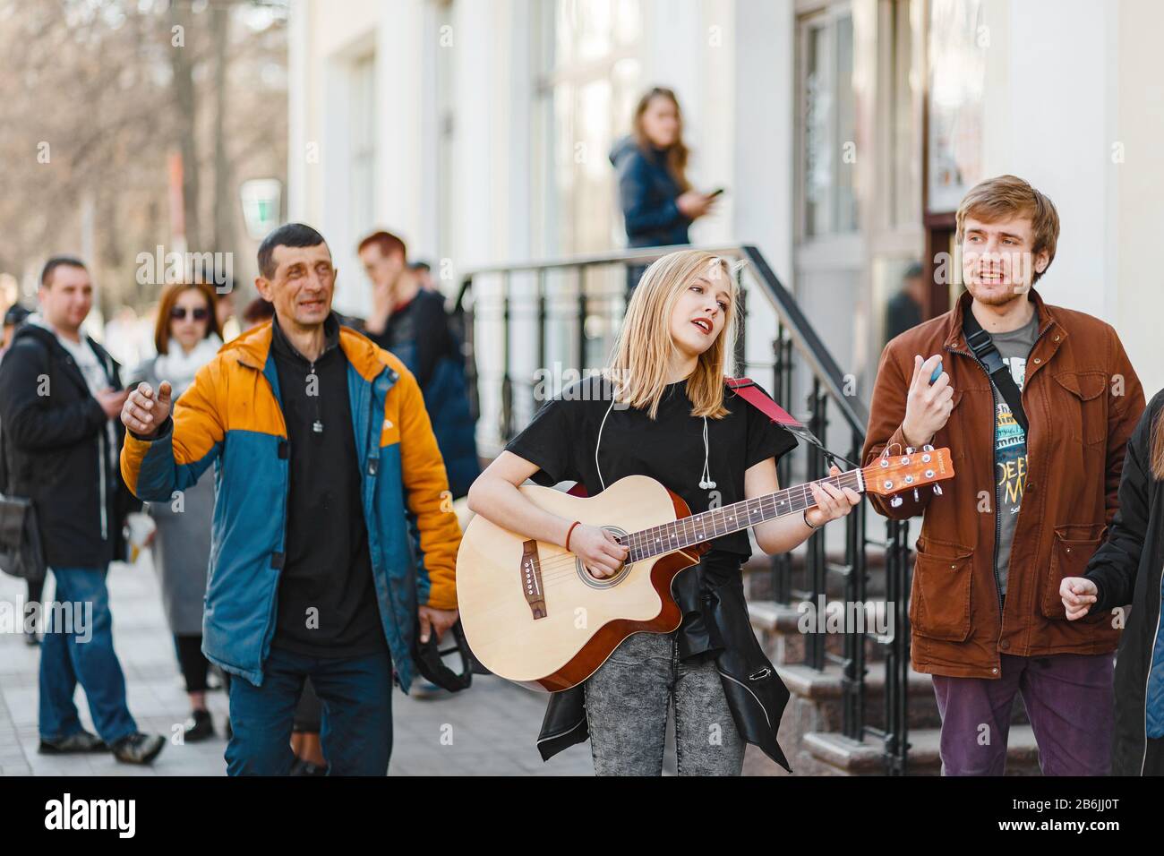 Busker girl playing guitar hi-res stock photography and images - Alamy