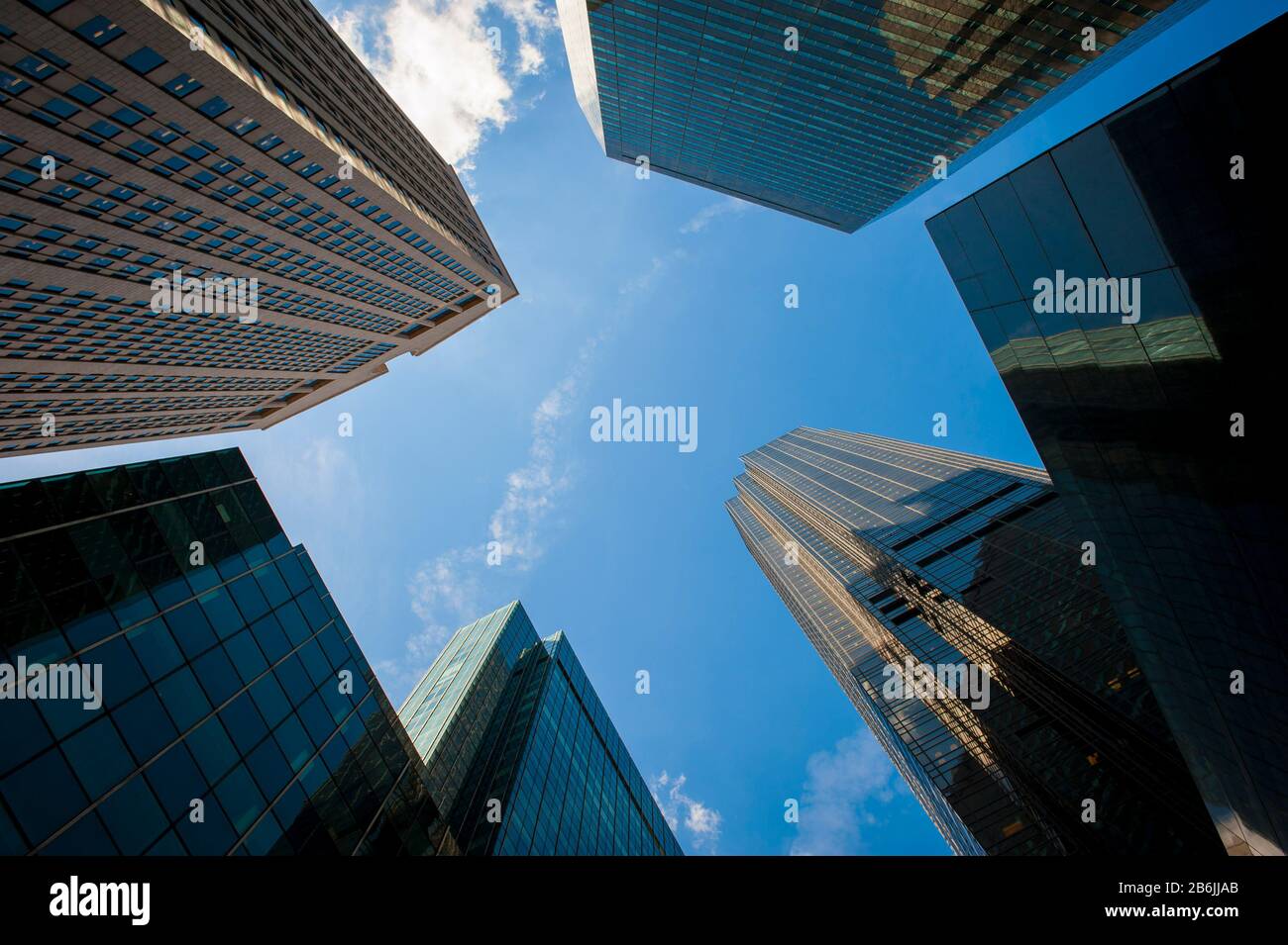 Abstract blue sky view of modern glass and steel skyscrapers from below ...