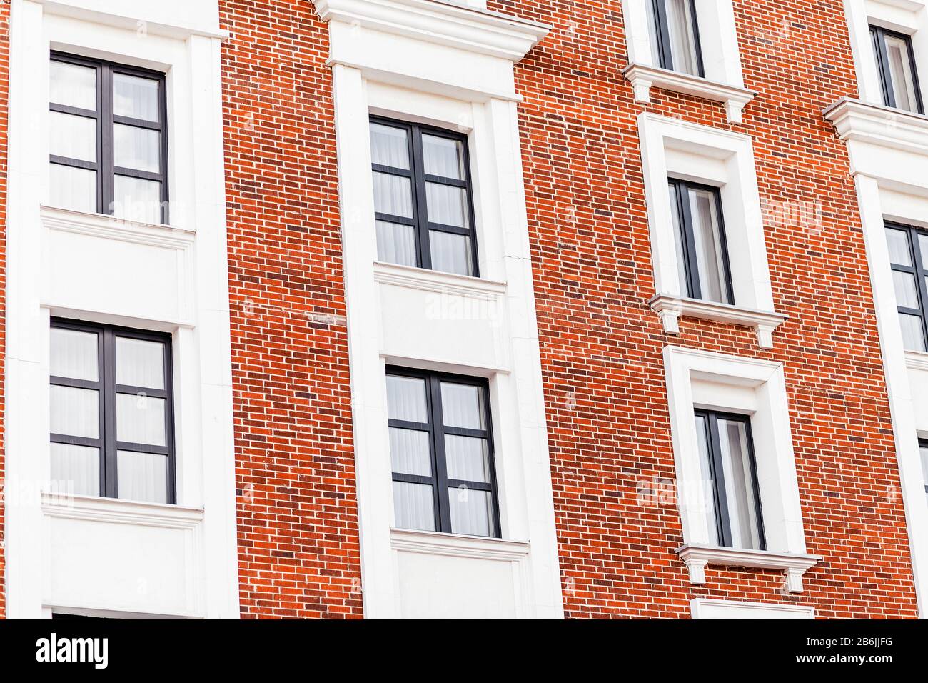 Red Brick building facade with windows Stock Photo - Alamy