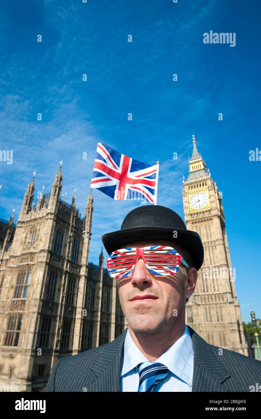 Serious British businessman wearing a traditional bowler hat with a ...
