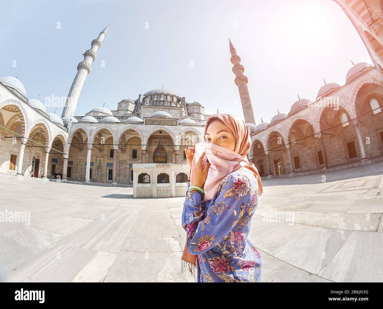 Happy attractive muslim woman in Istanbul, Turkey, posing in courtyard ...