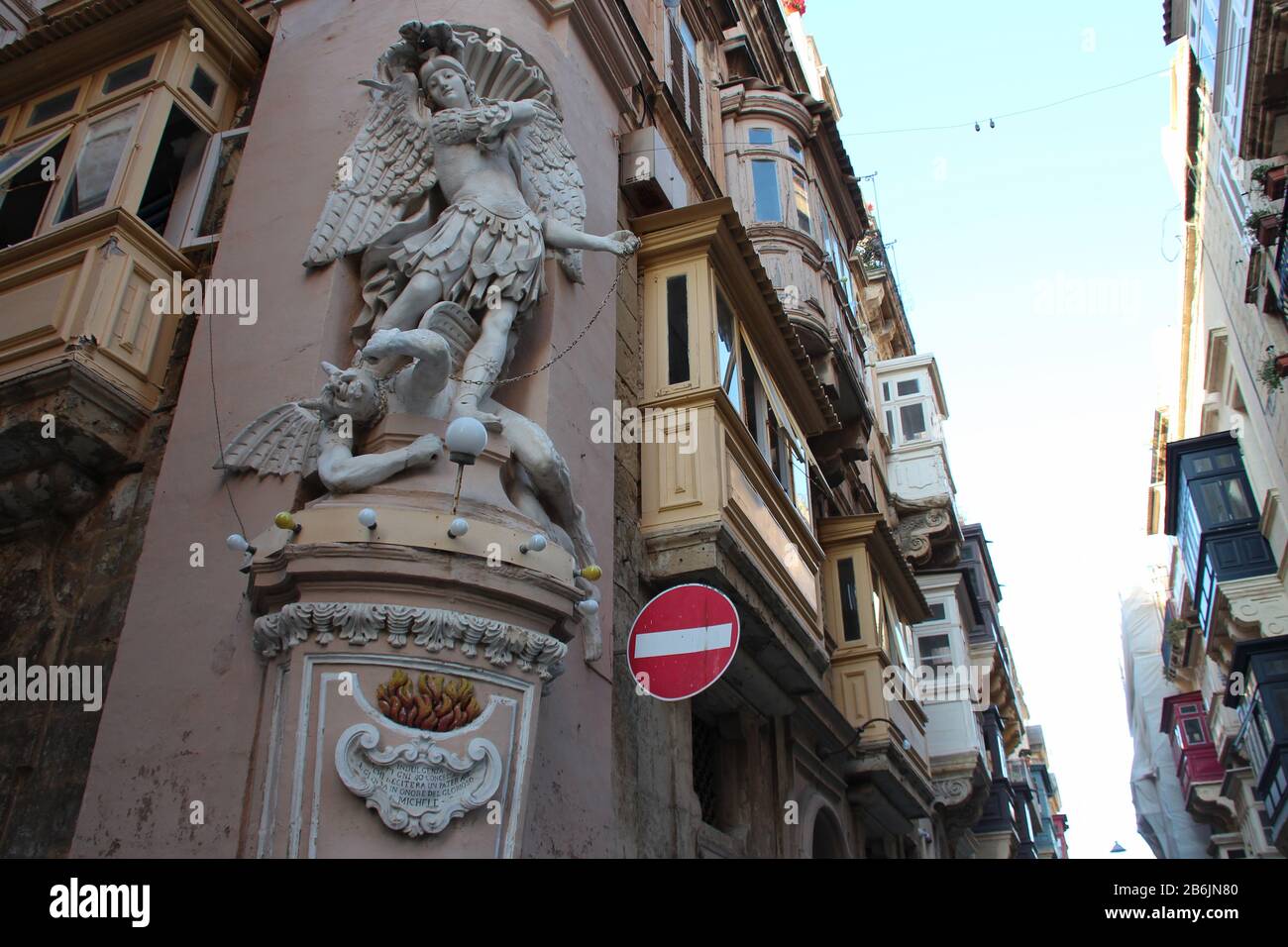 statue of holy character (archangel michael) and flats buildings in ...