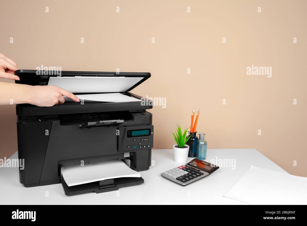 Woman using the printer to scanning and printing document Stock Photo ...