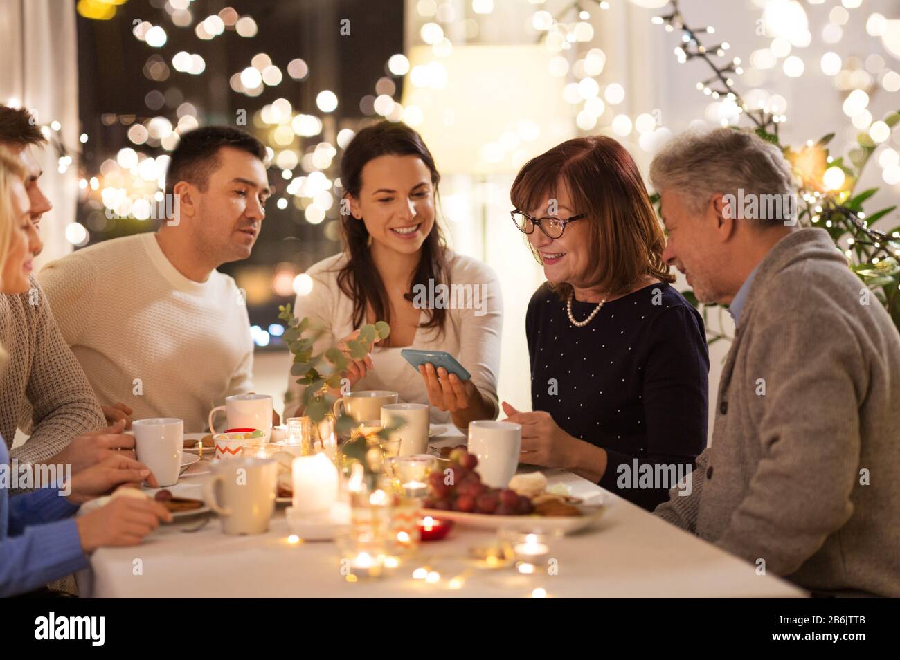 celebration, holidays and people concept - happy family with smartphone ...