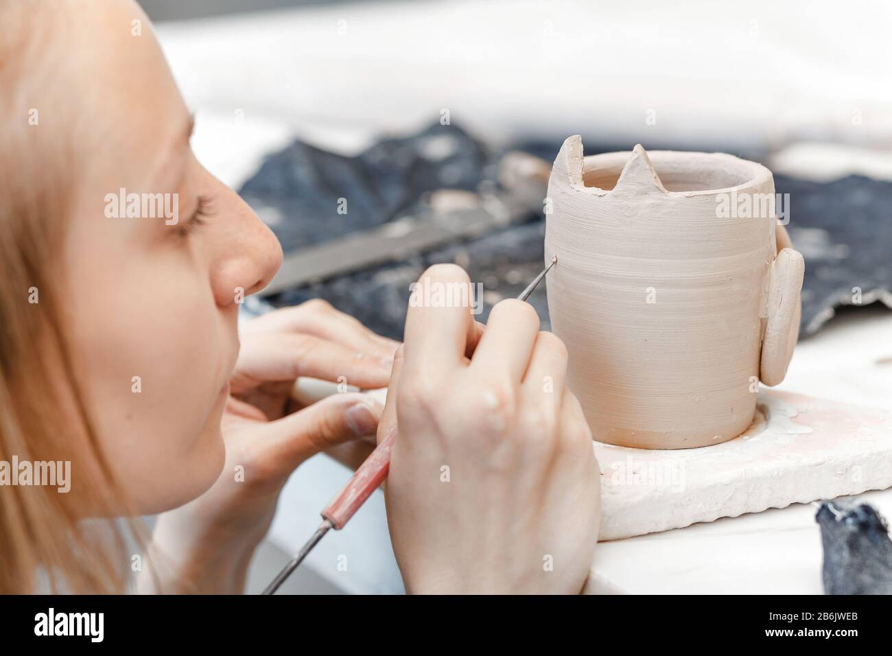 Pottery artist decorating ceramic pot hi-res stock photography and ...