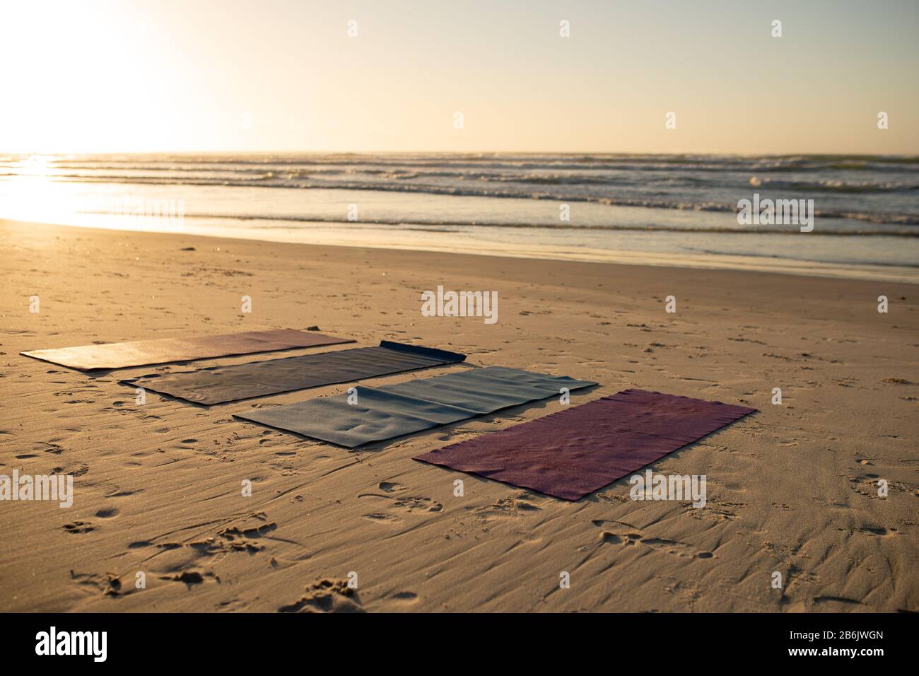 Side view of yoga mats at the beach Stock Photo - Alamy