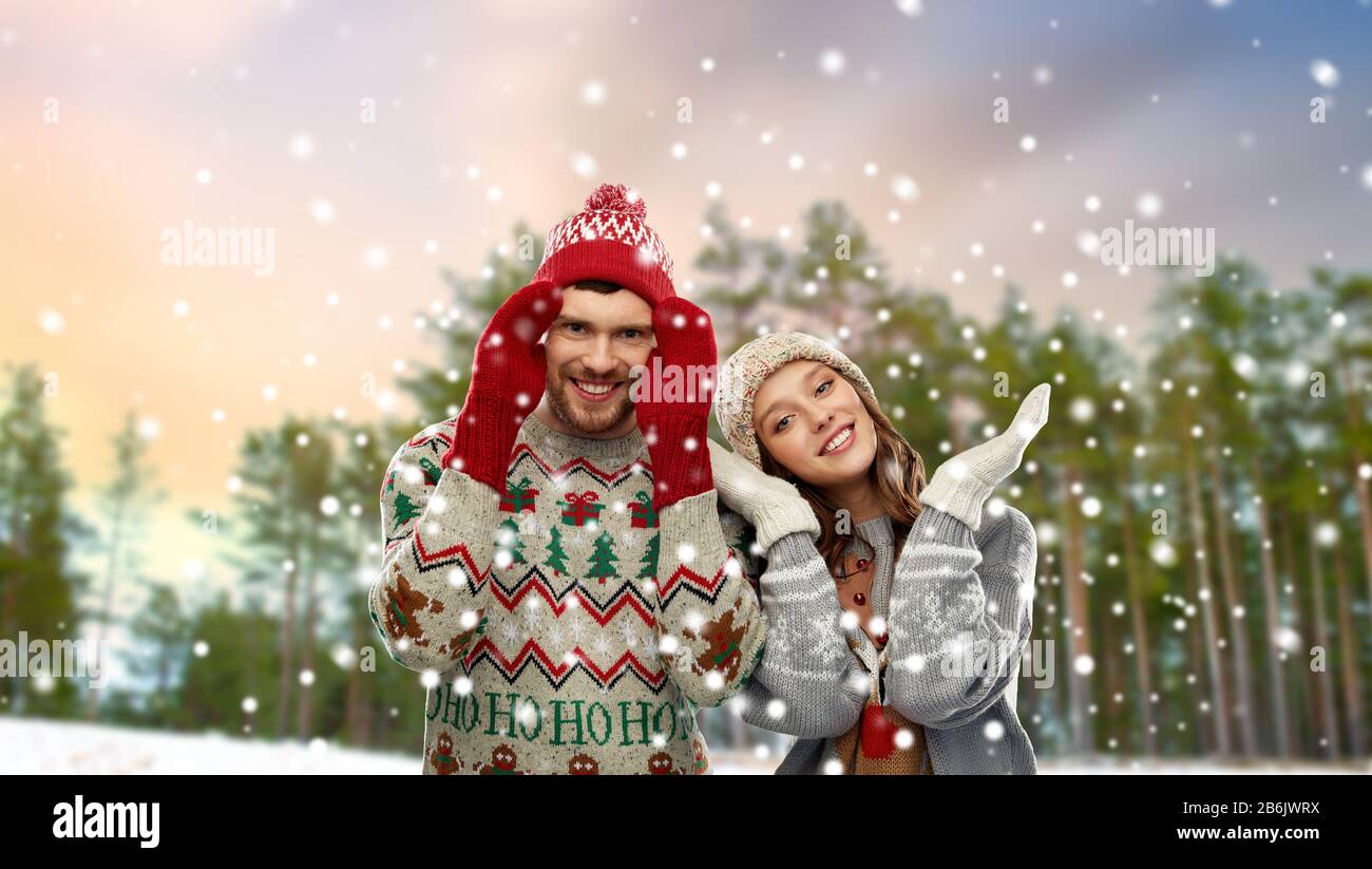 christmas, clothes and holidays concept - portrait of happy couple in ...