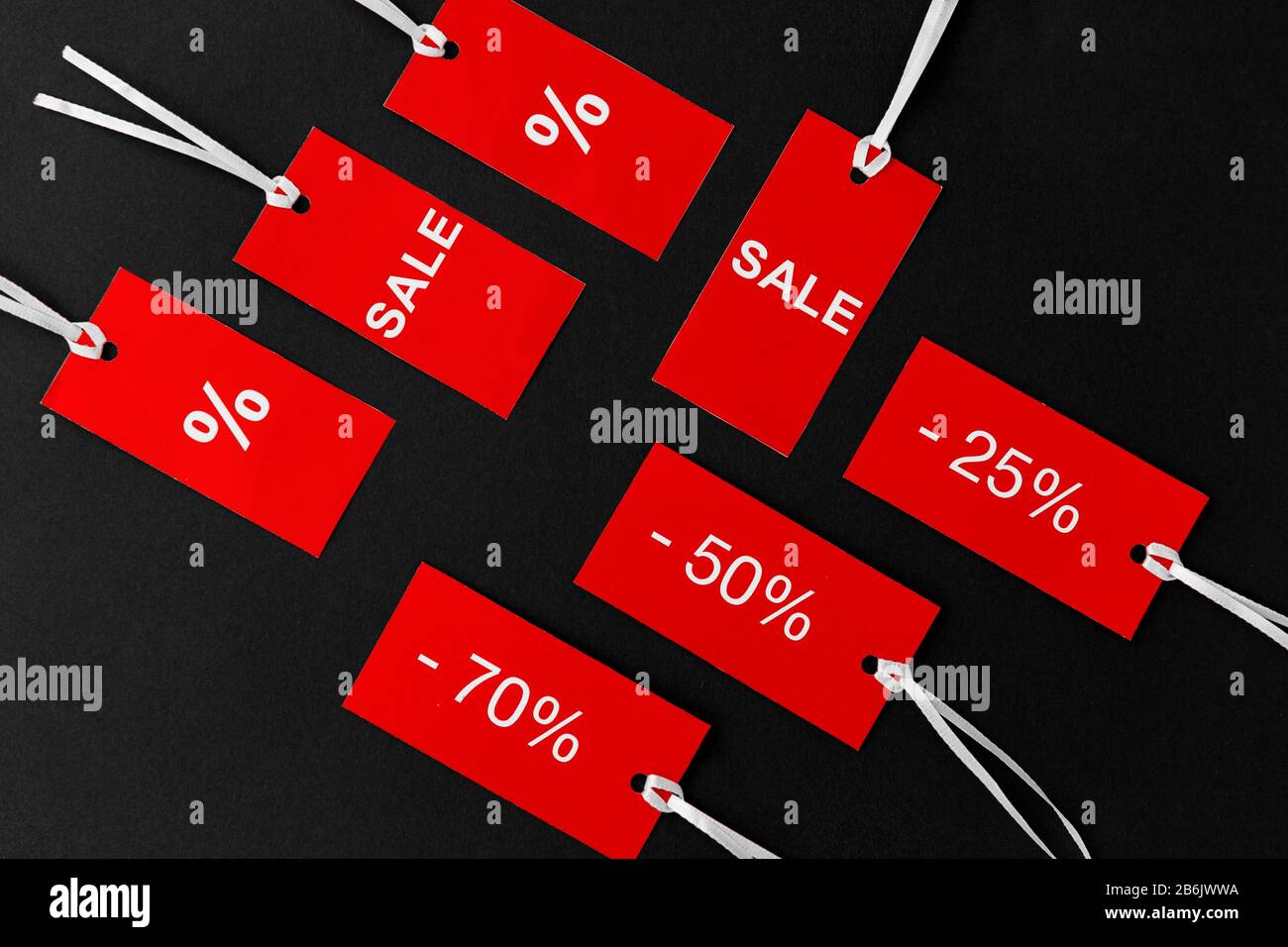 shopping, sale and outlet concept - red tags with discount signs on ...