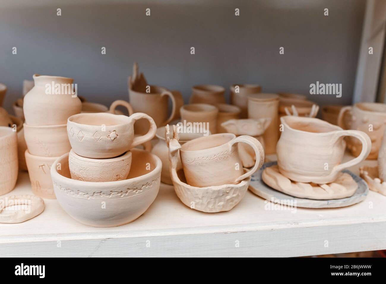 Empty clay pots drying on a shelf Stock Photo - Alamy