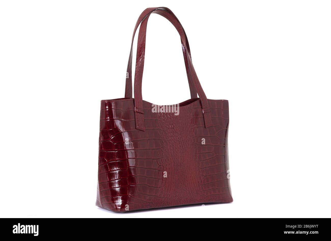 expensive red female leather bag on a handle isolated on a white ...