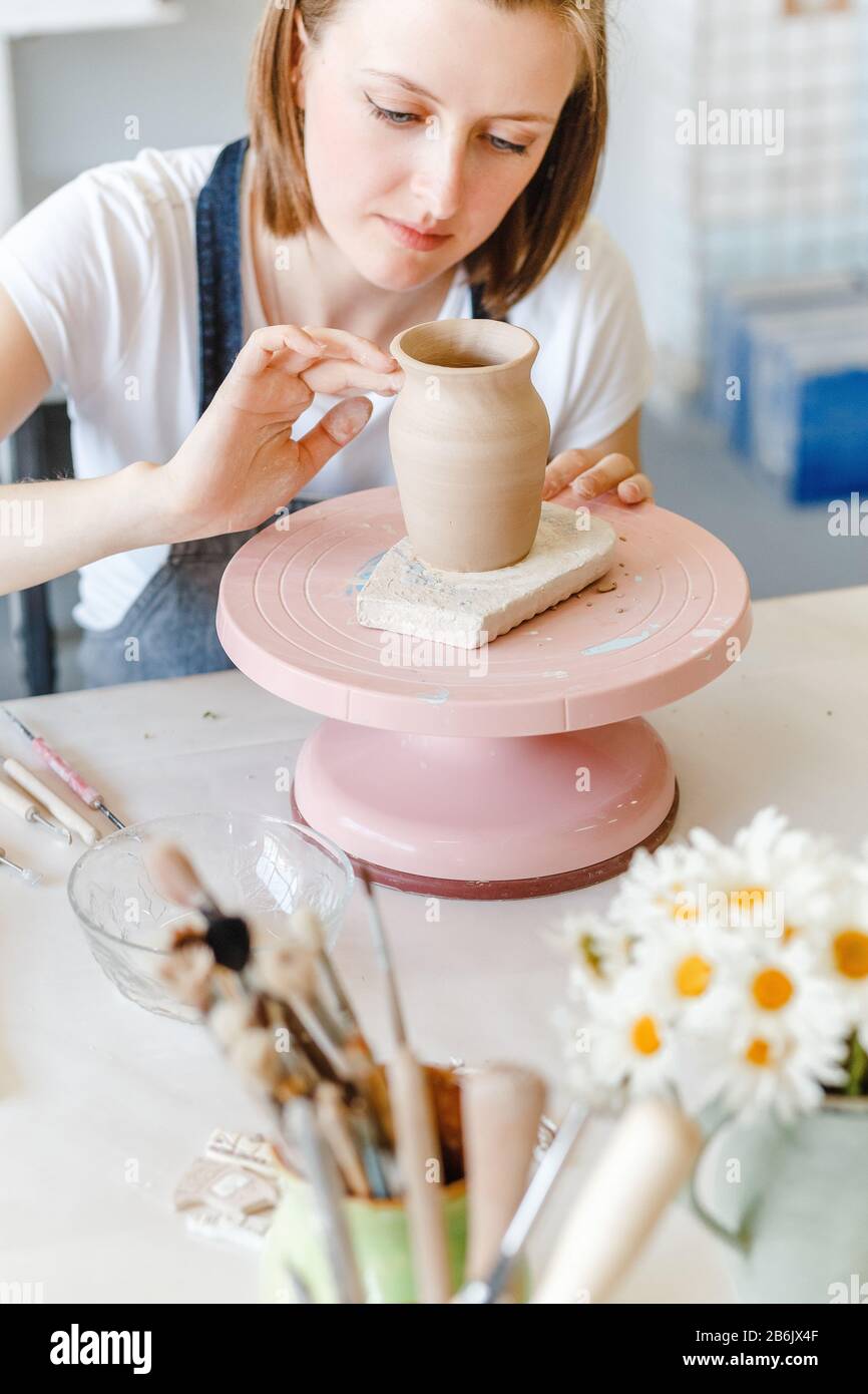 Workshop of clay pottery ceramic, woman decorating dishware pot Stock ...