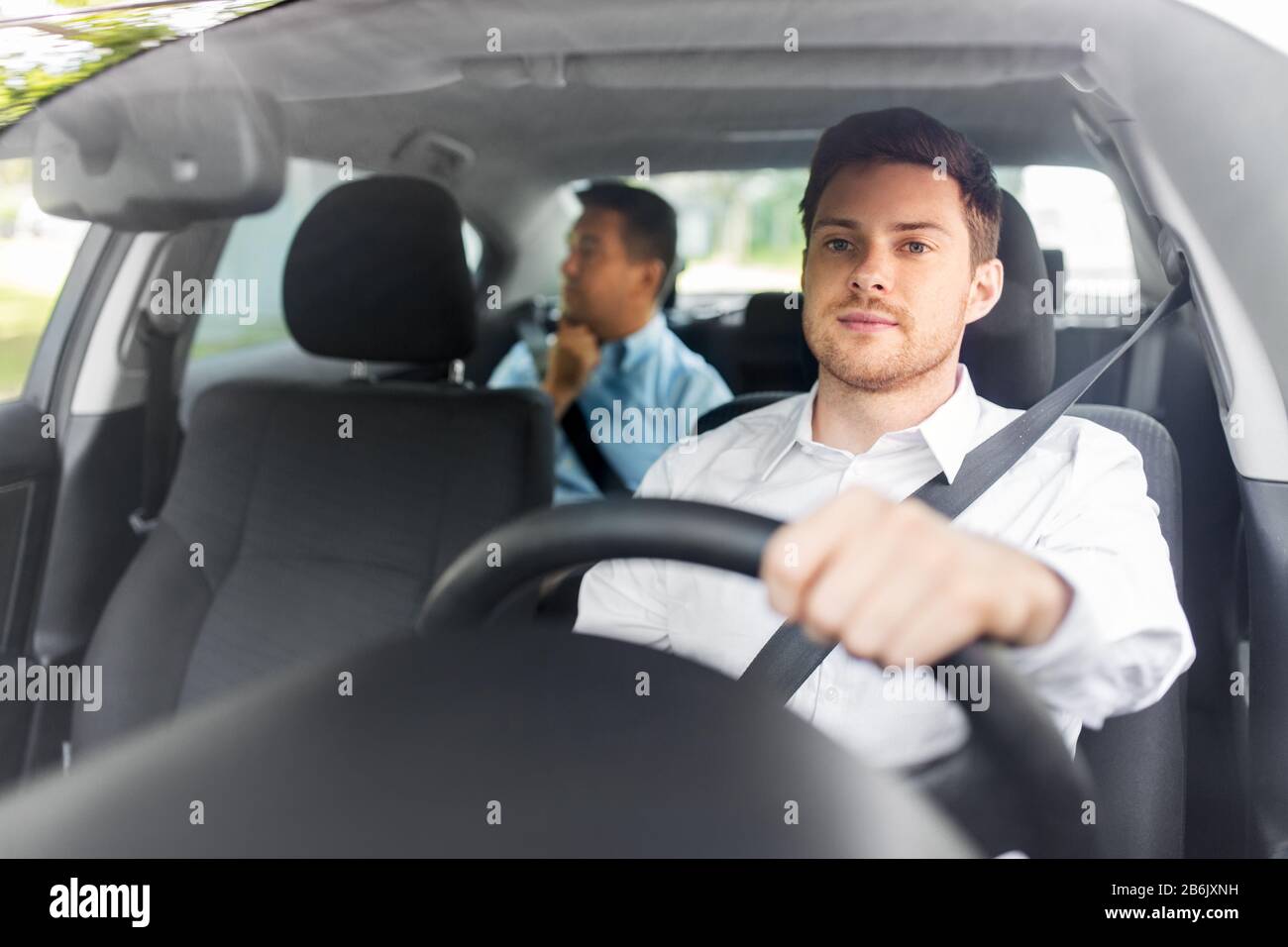 transport, vehicle and people concept - male driver driving car with ...