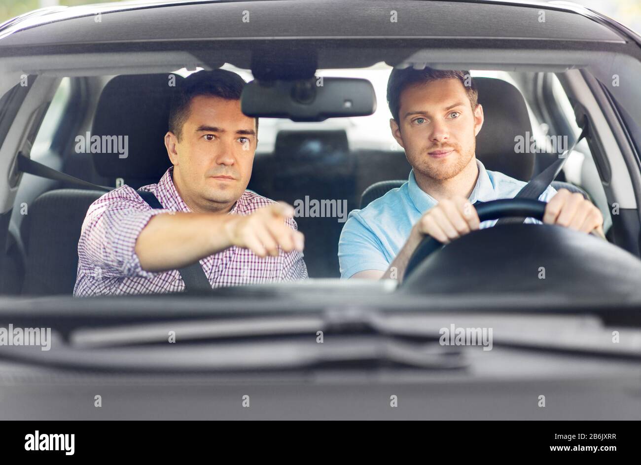 driver courses and people concept - car driving school instructor ...