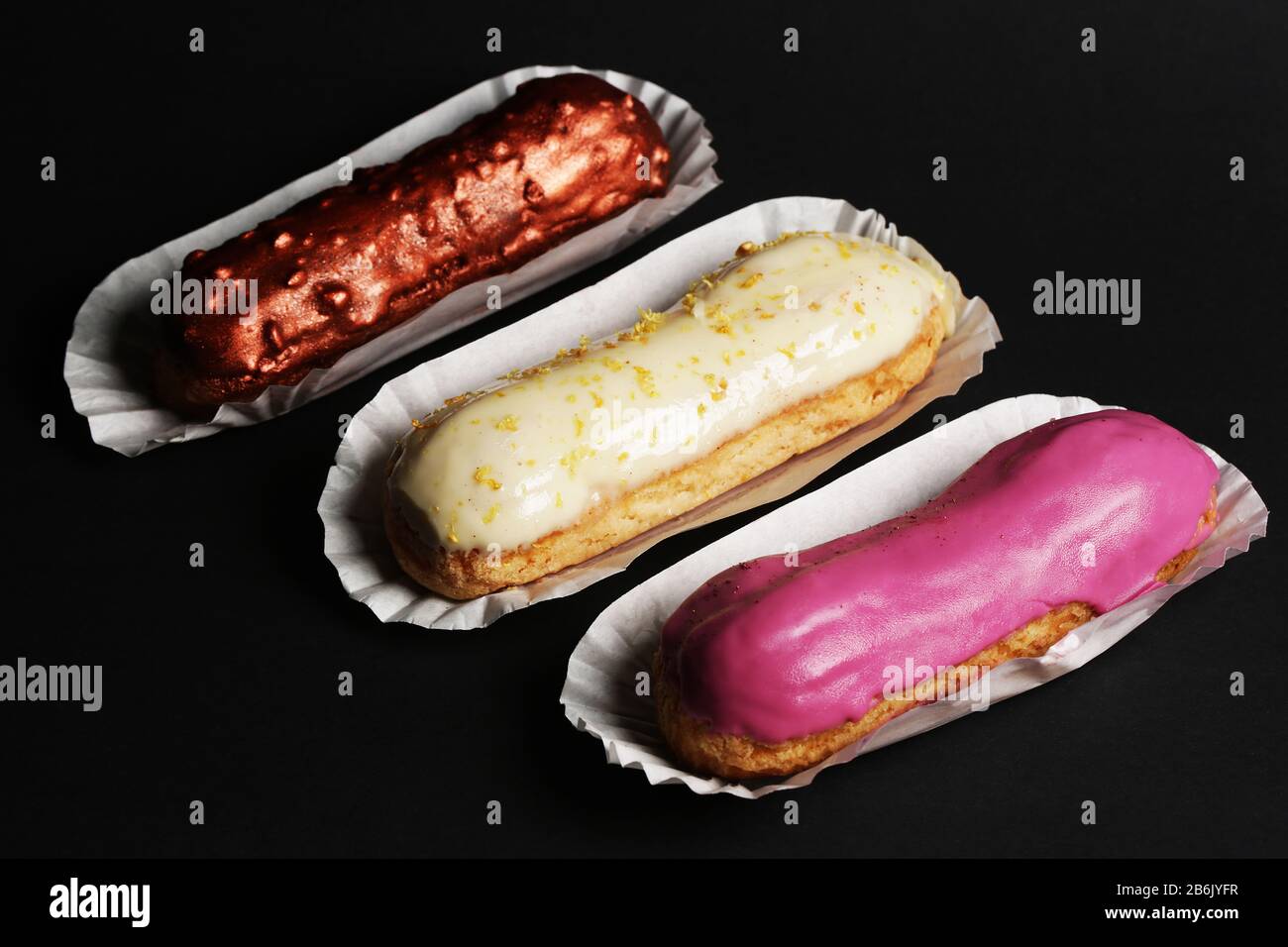 Eclair french cake delicious dessert on black background close up food ...