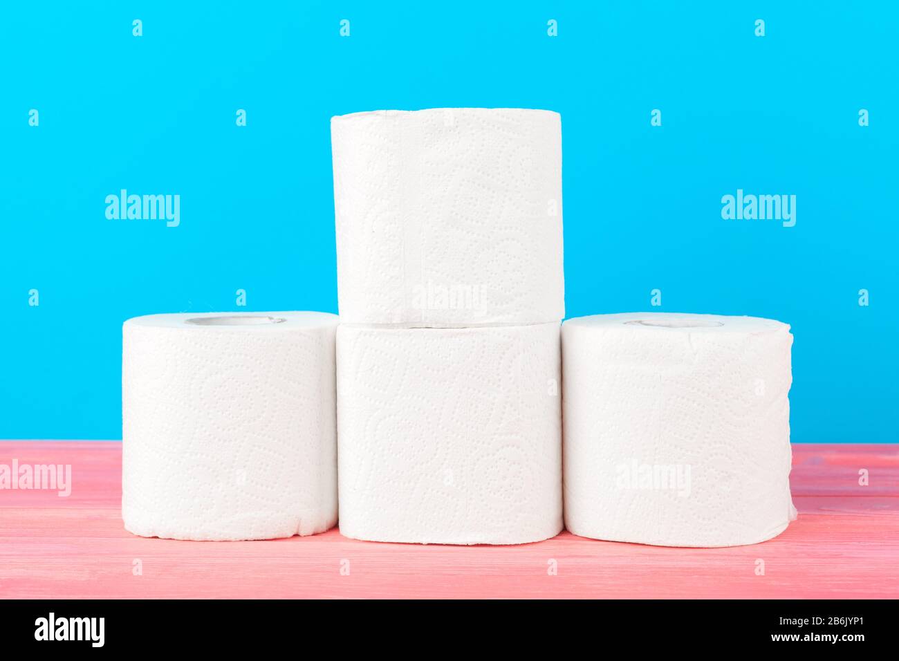 Toilet paper stack on bright blue background Stock Photo - Alamy