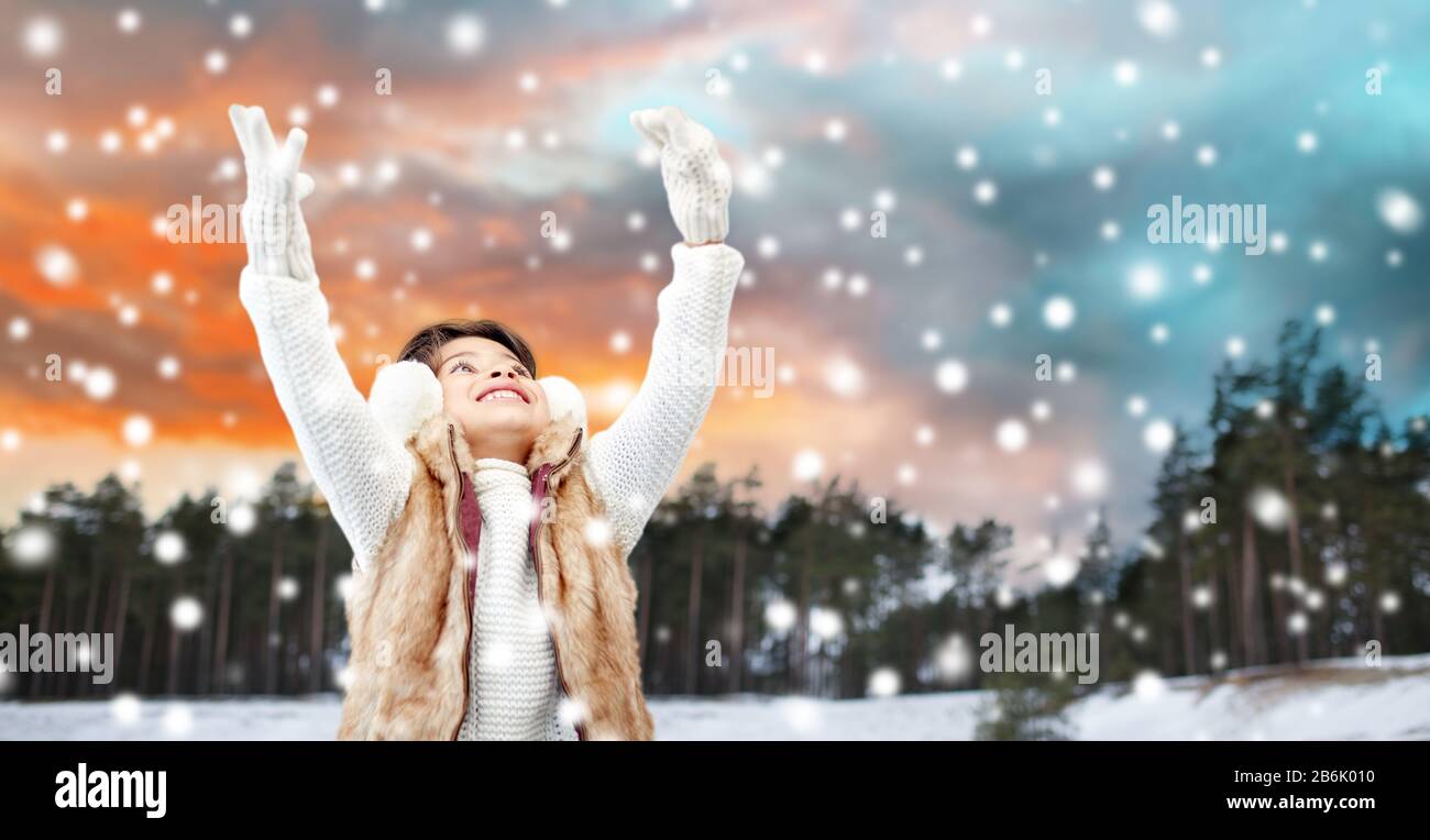 christmas, season and happiness concept - happy little girl enjoying ...