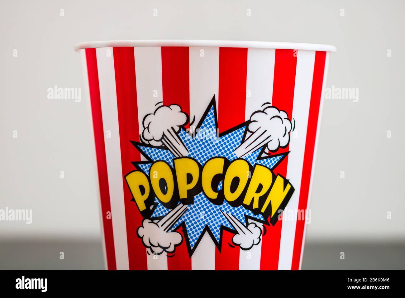 Plastic container for popcorn isolated close up photo. Popcorn sign on ...