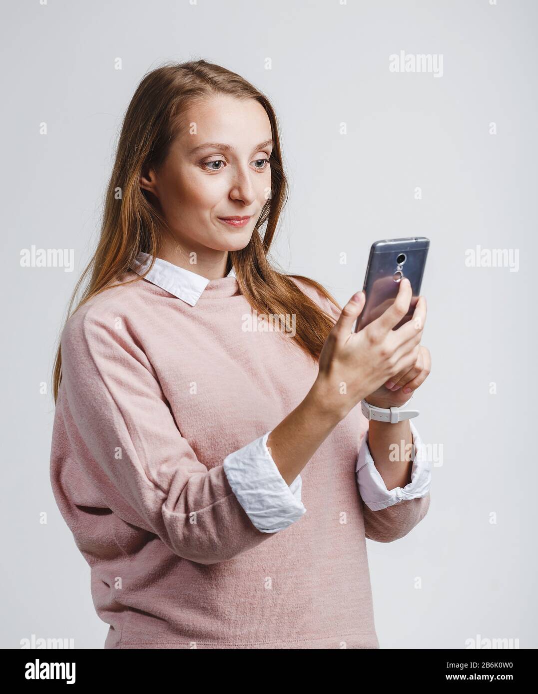 Happy woman phone talking at white studio background Stock Photo - Alamy