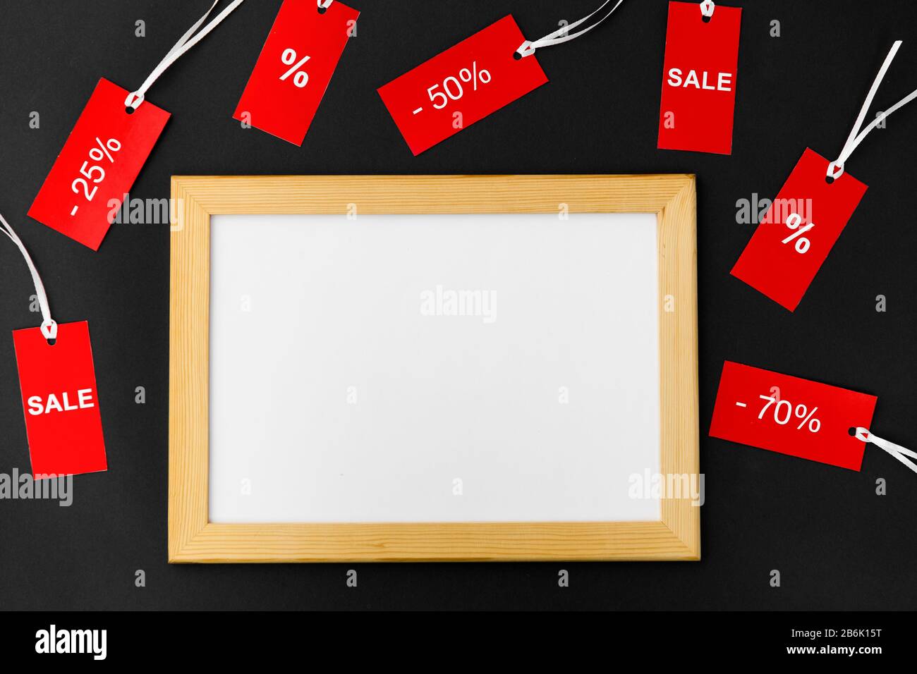shopping and outlet concept - white board and red tags with discount ...