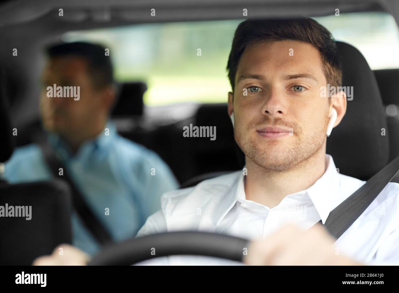 transport, taxi and people concept - male driver with wireless ...