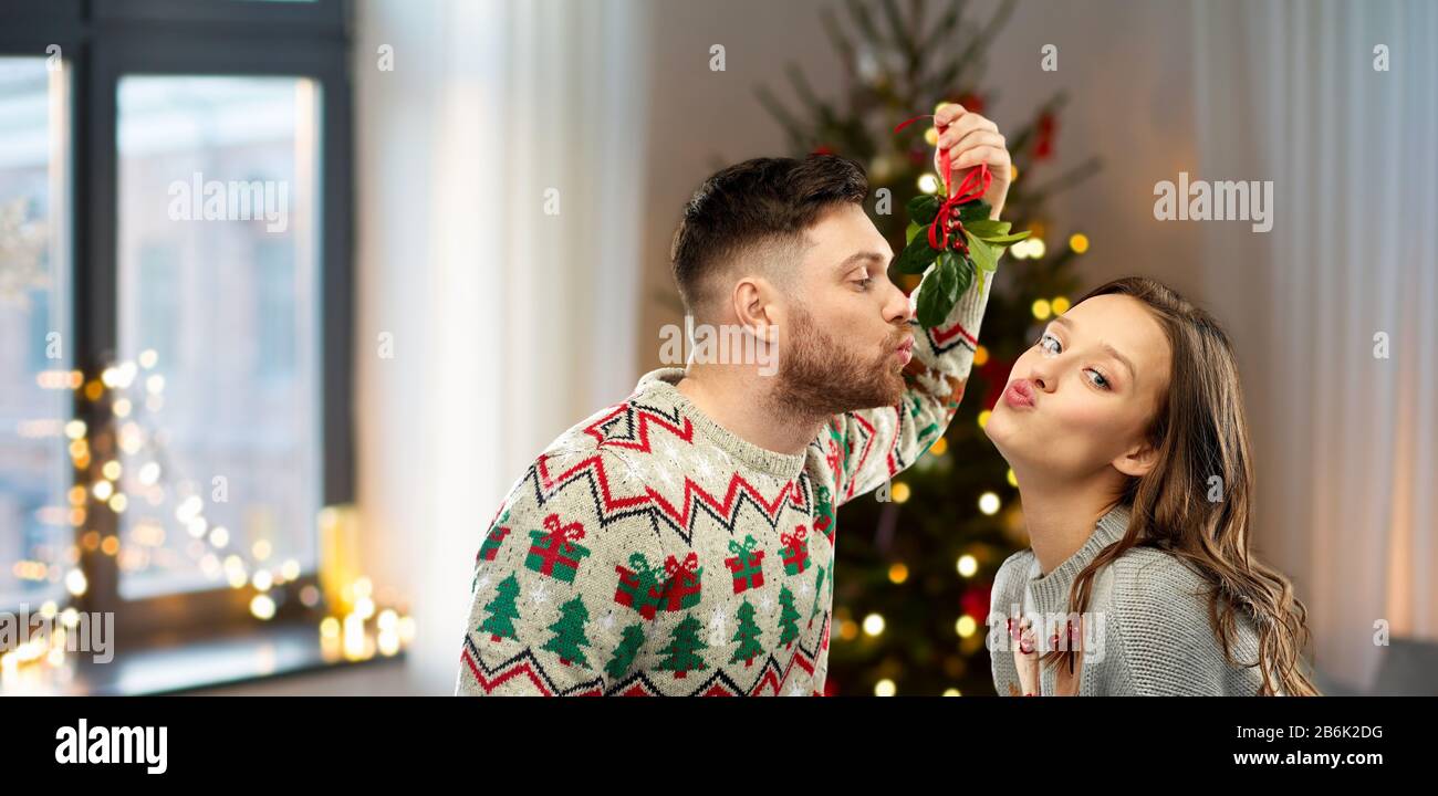 Couple kissing under mistletoe hi-res stock photography and images - Alamy