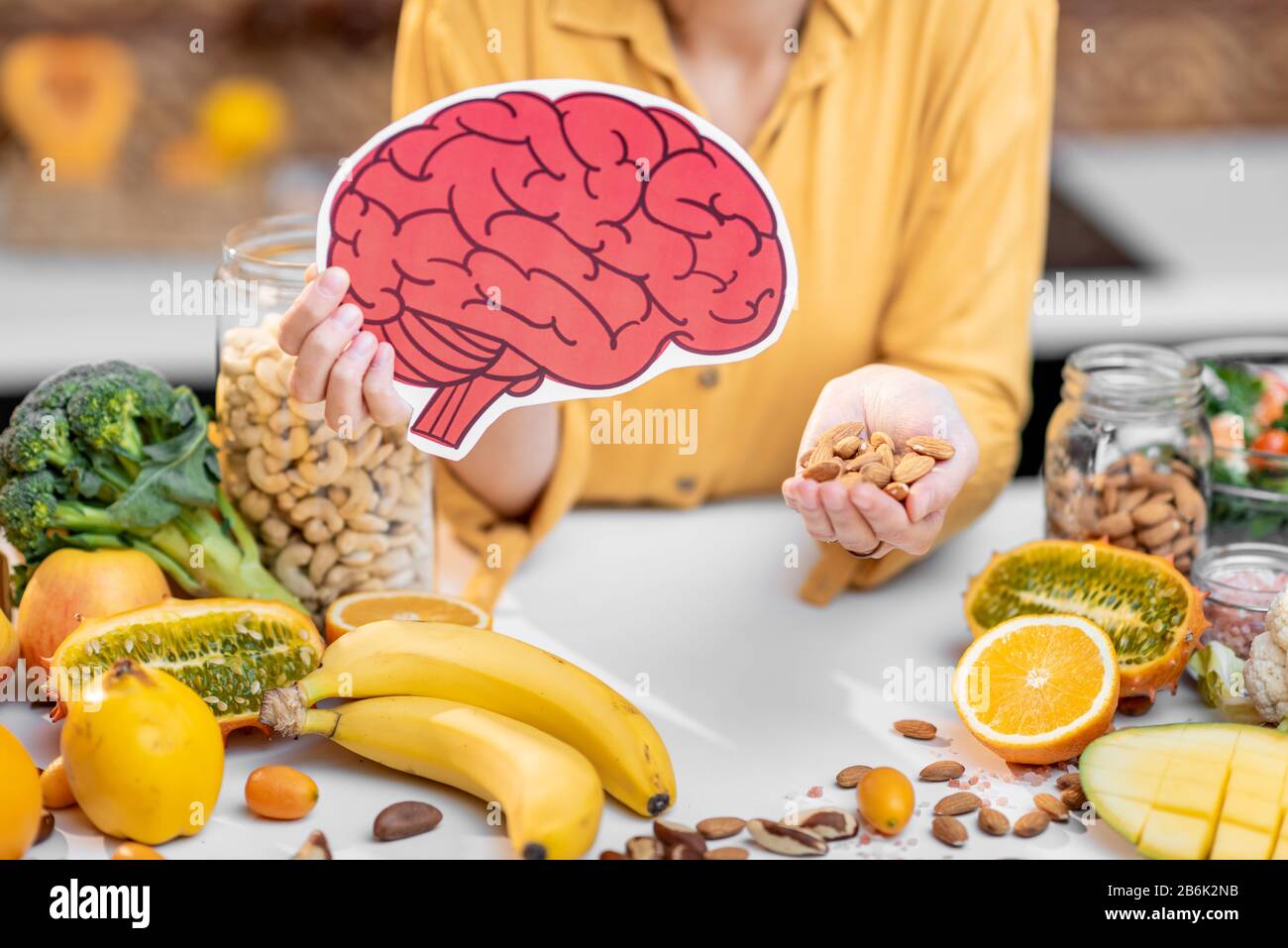 Holding human brain model with variety of healthy fresh food on the ...