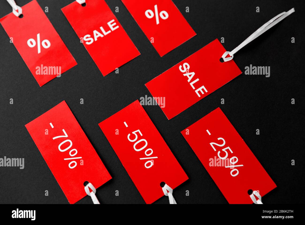 shopping, sale and outlet concept - red tags with discount signs on ...