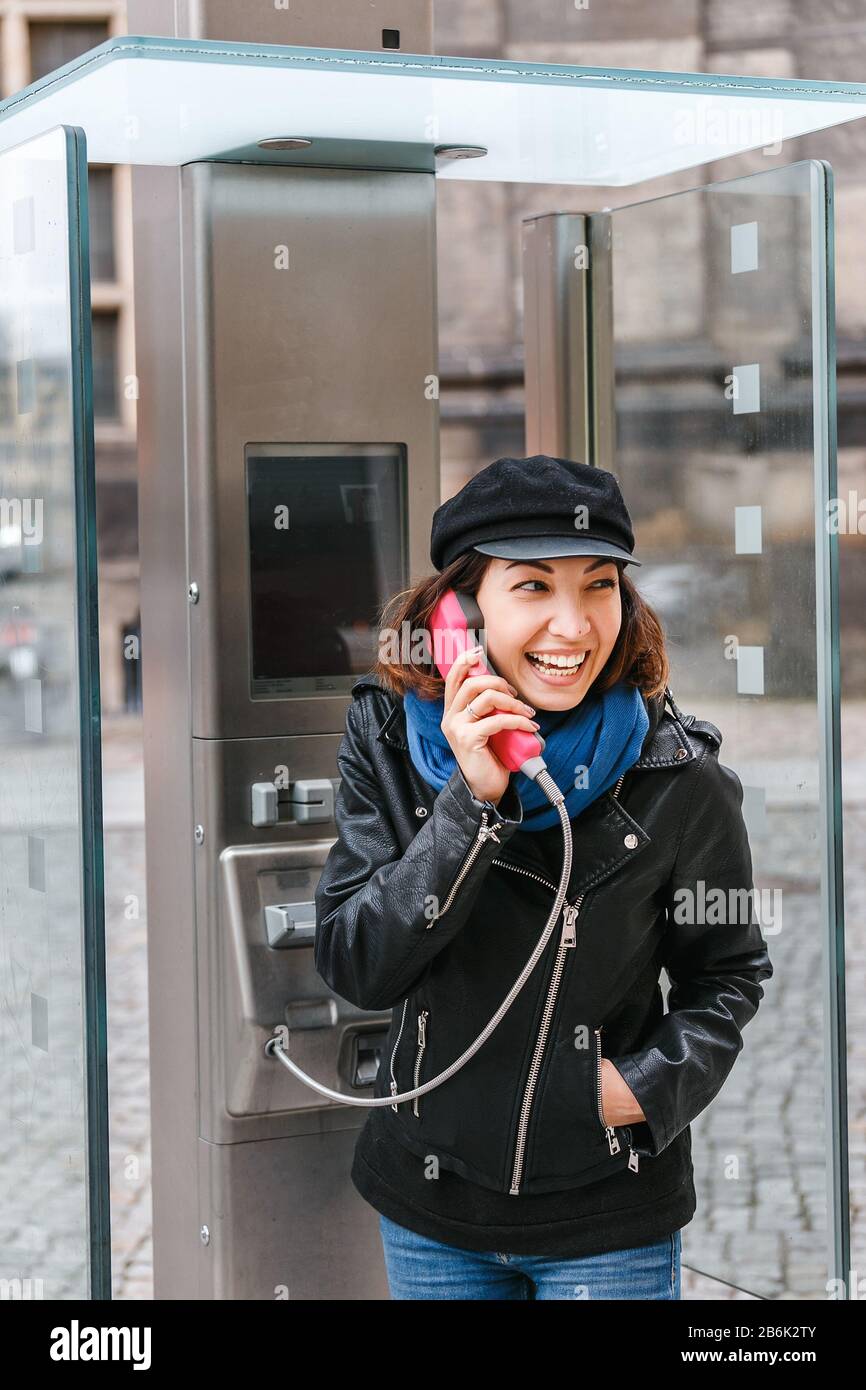 Portrait of happy and smiling tourist woman talking in the modern ...