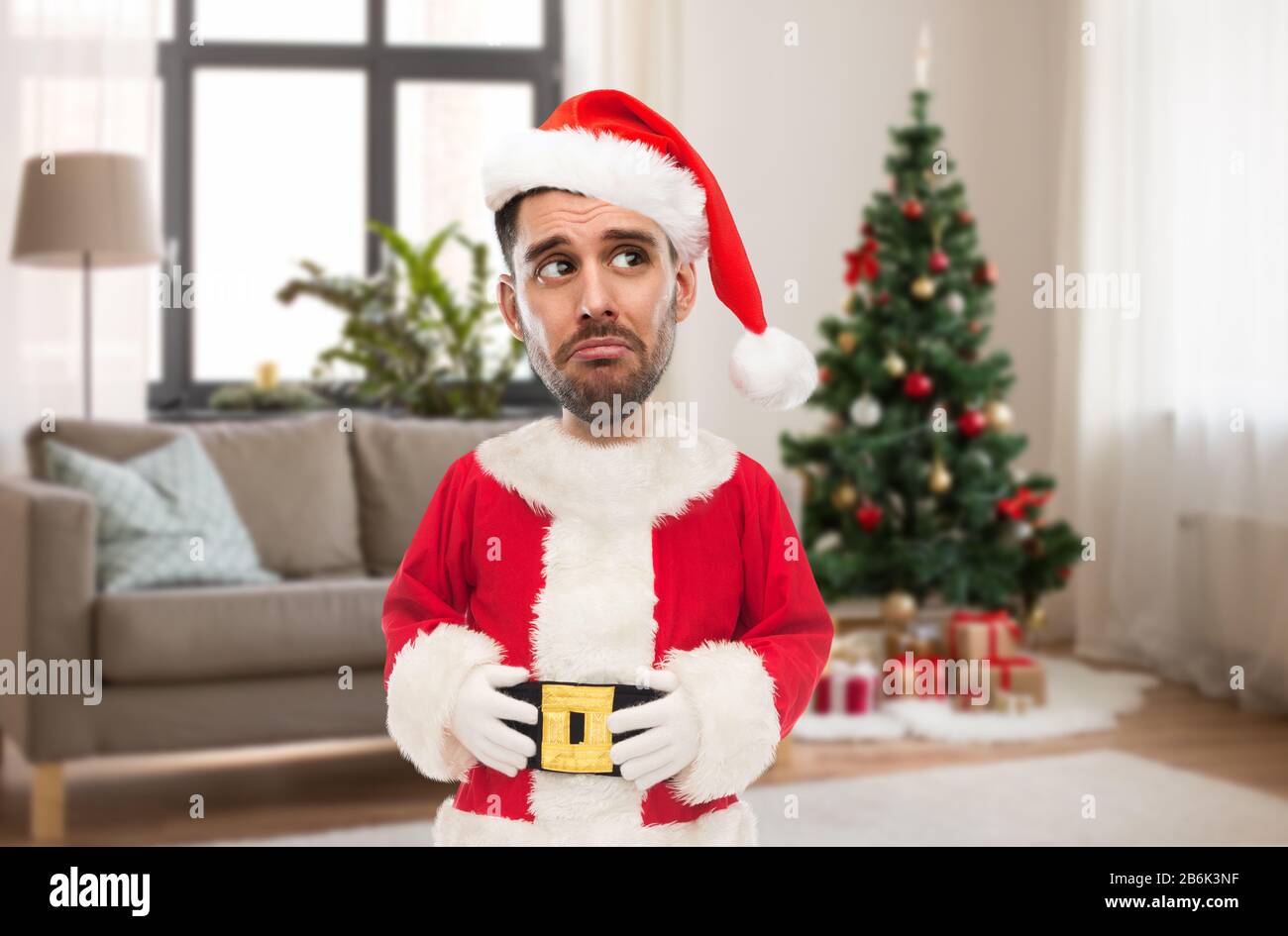 emotion, expression and winter holiday concept - sad man in santa claus ...