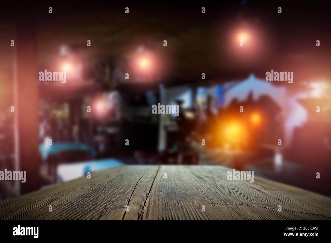 Dark blurred background of bar restaurant and old brown wooden table ...